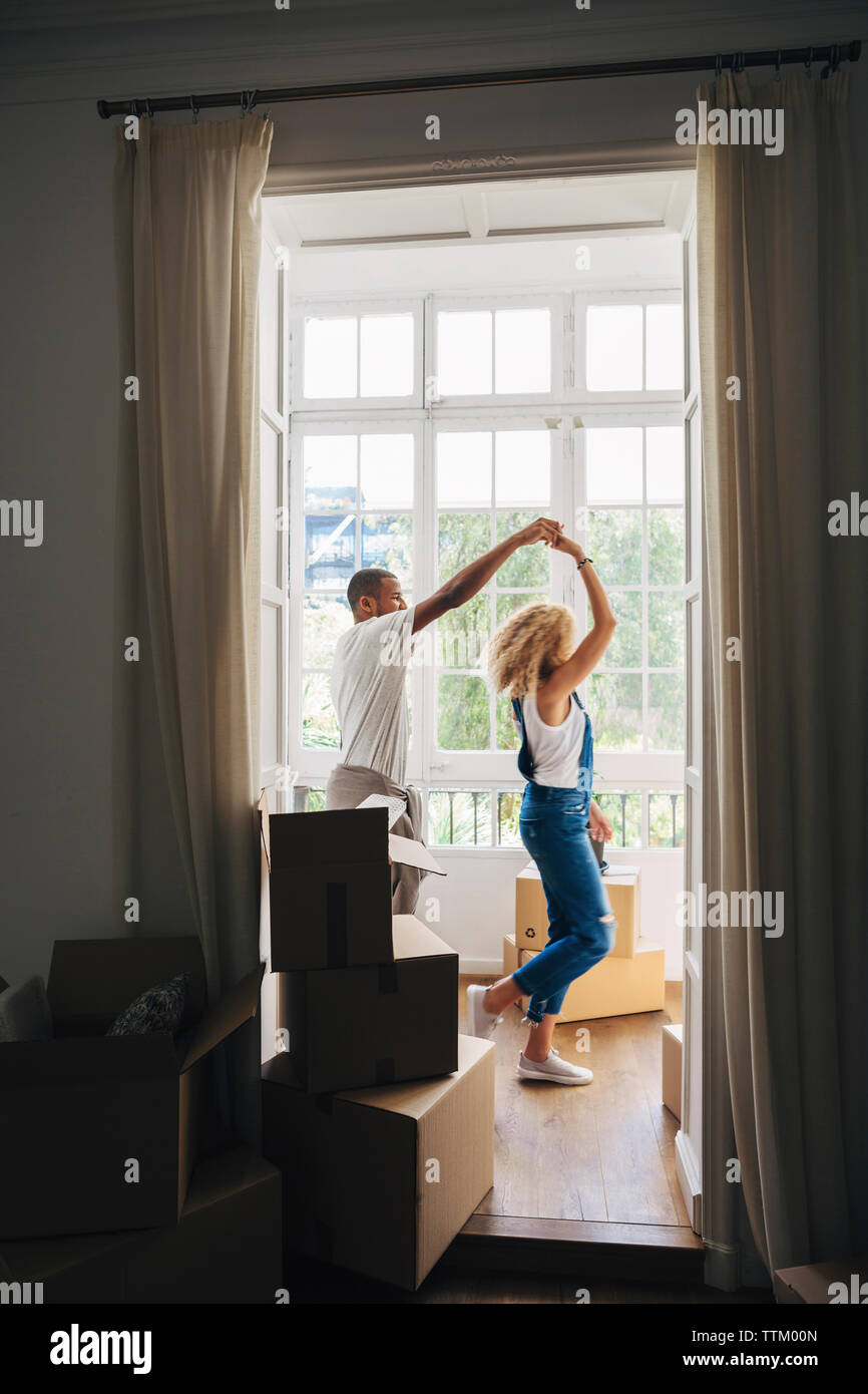 Couple dancing in new house seen through doorway Stock Photo - Alamy