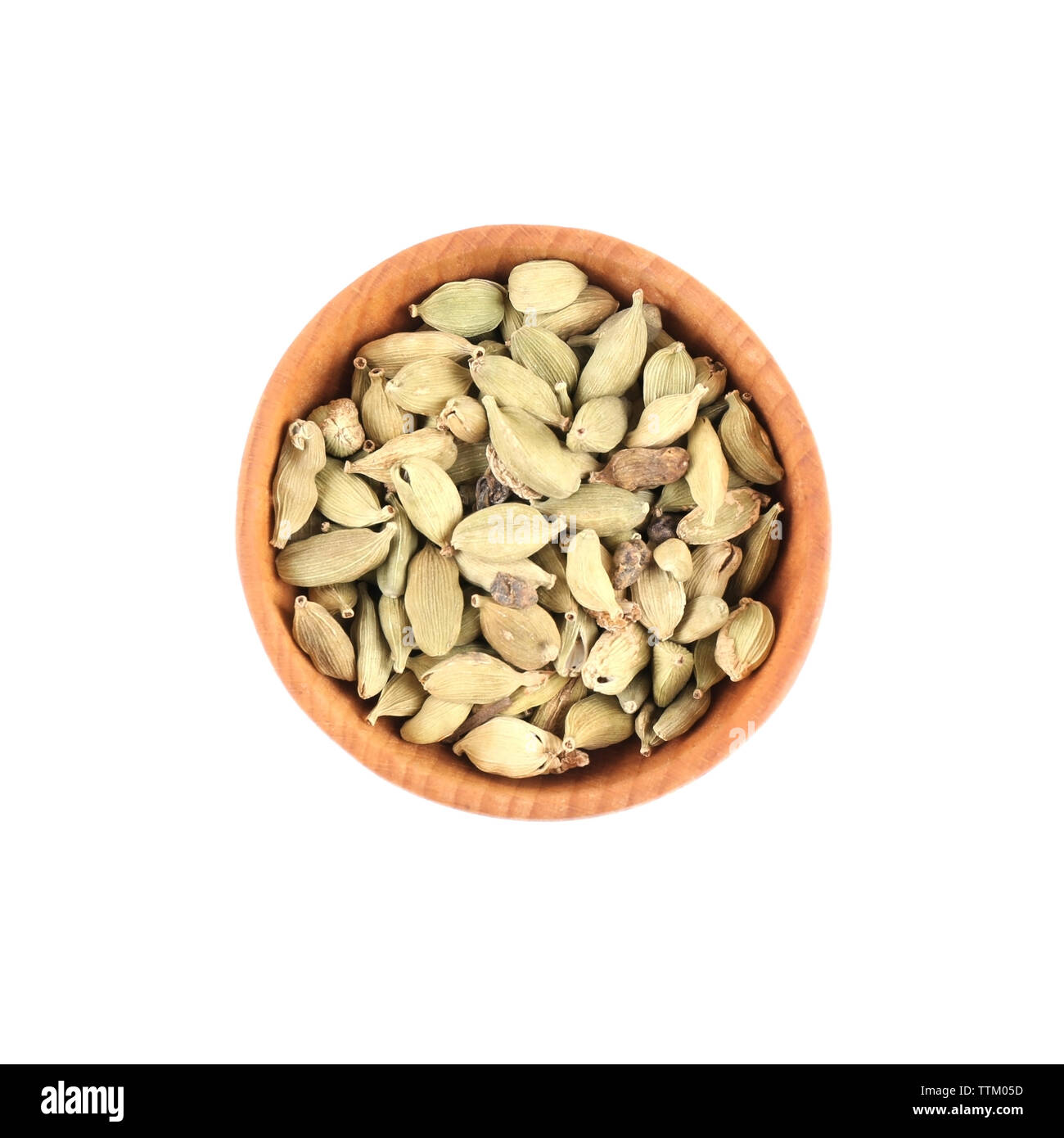 Cardamom seeds in small wooden bowl isolated on white Stock Photo - Alamy