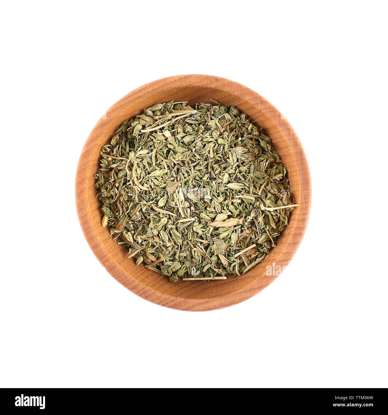Dried tarragon in small wooden bowl isolated on white Stock Photo - Alamy