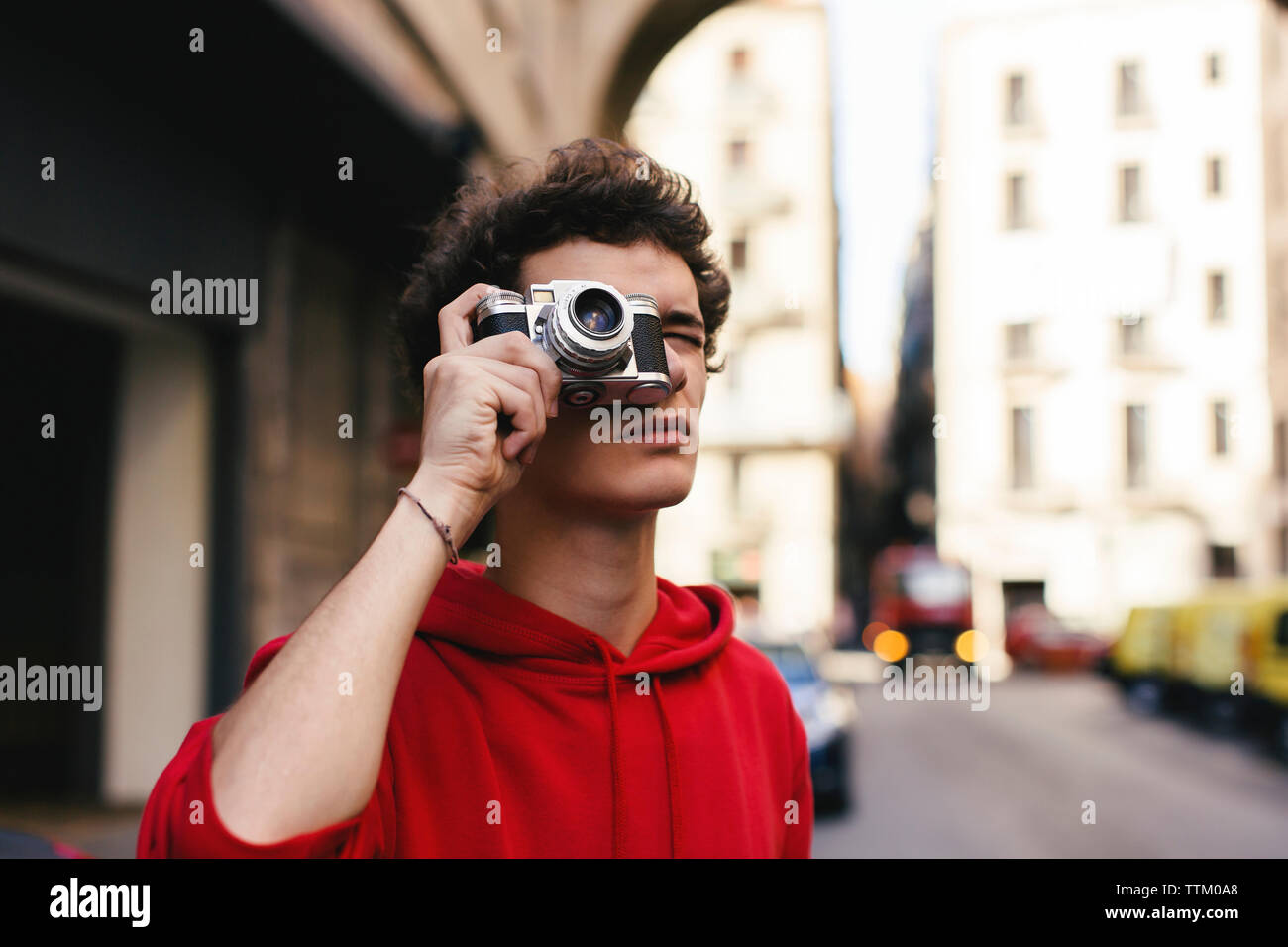 Tourist photographing with camera in city Stock Photo - Alamy