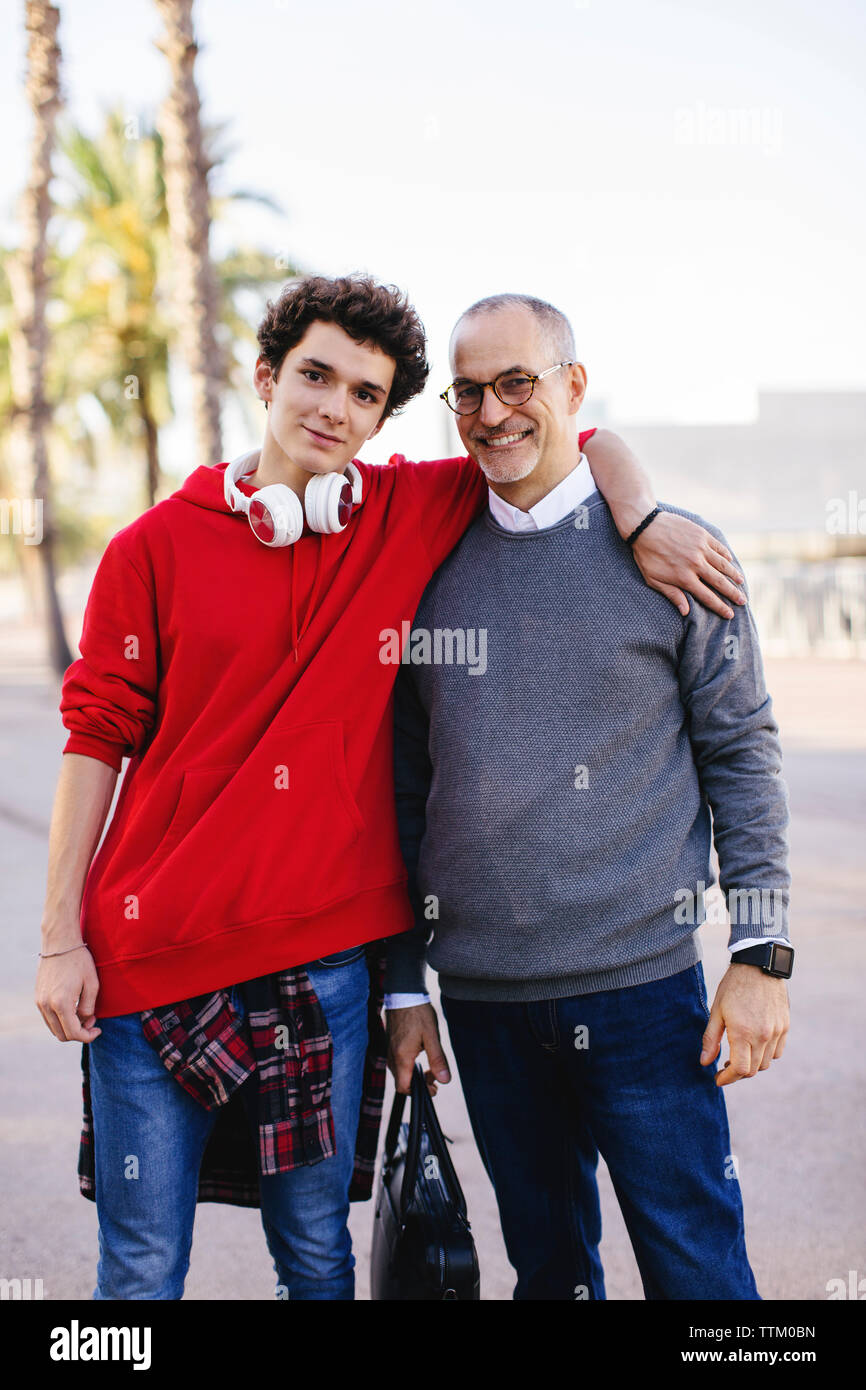 Portrait of confident son and father in city Stock Photo - Alamy