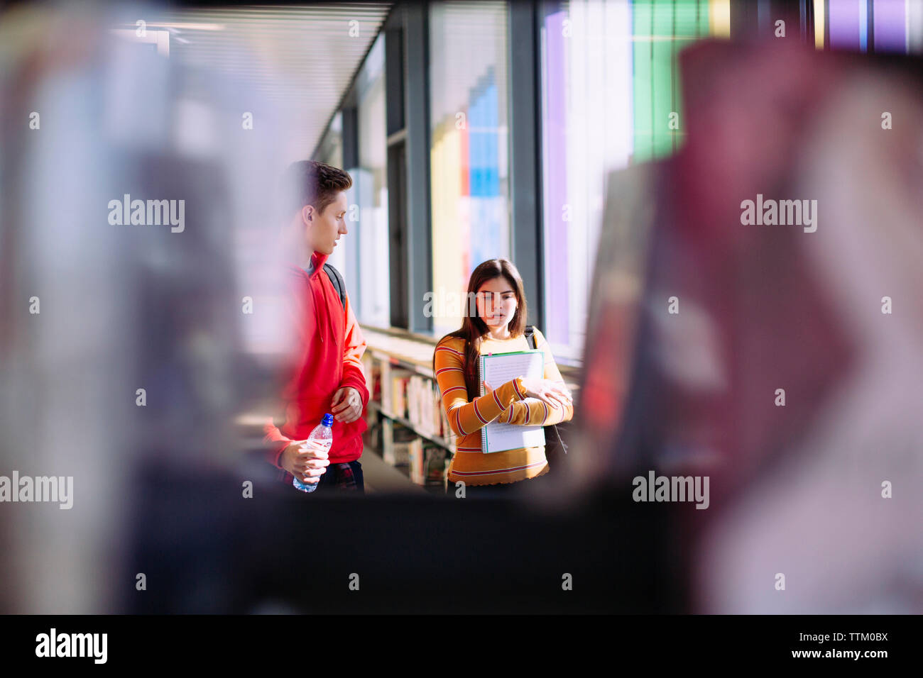 Man standing in front bookshelf hi-res stock photography and images - Alamy