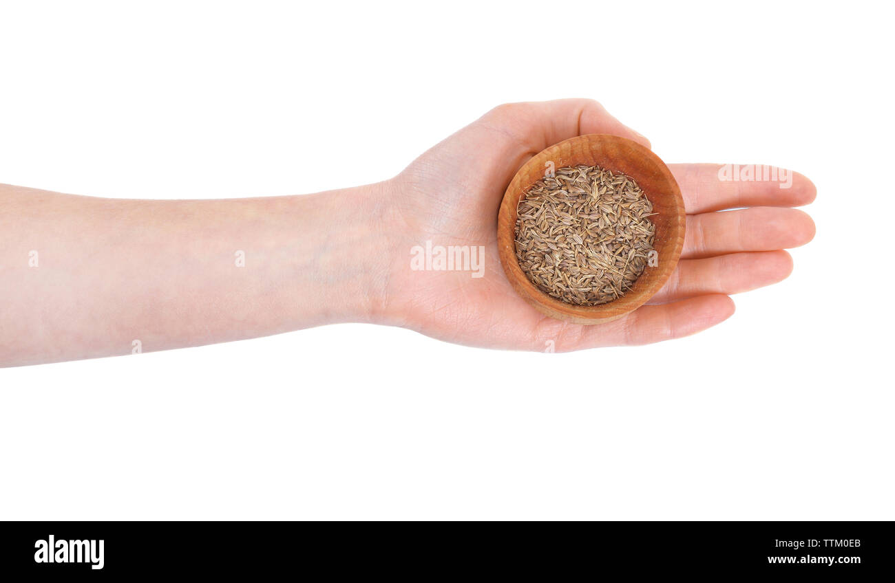 Hand holding wooden bowl with cumin seeds isolated on white Stock Photo ...