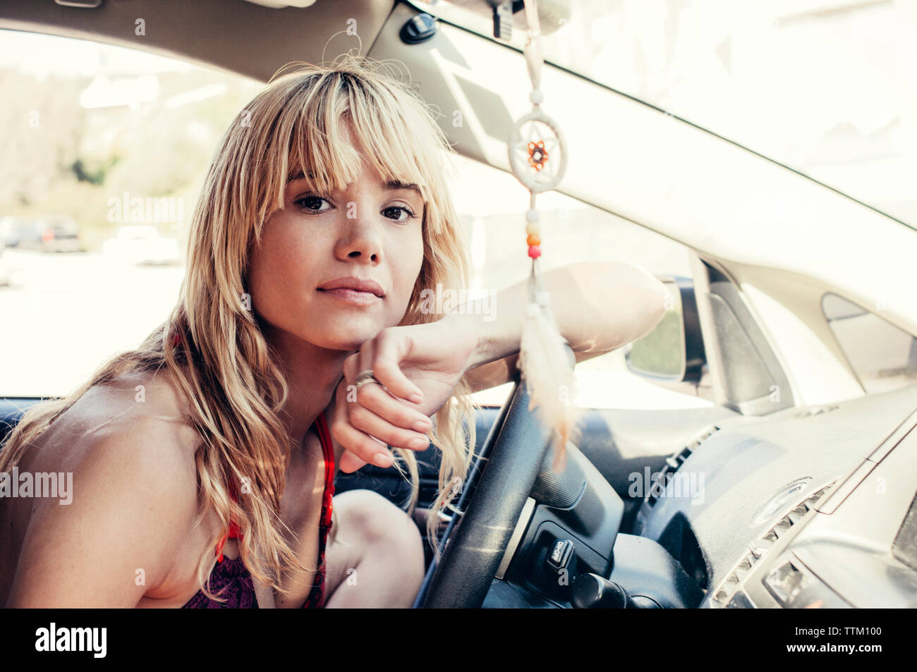 Side view portrait of beautiful woman sitting in car Stock Photo - Alamy