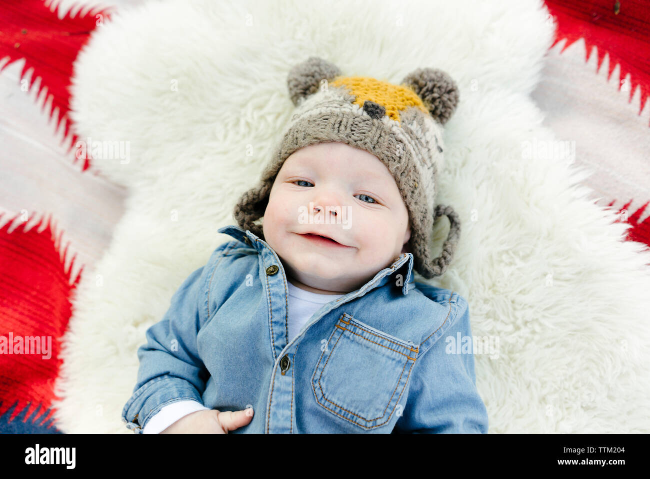 View from above of a baby boy smiling while laying on a blanket Stock ...