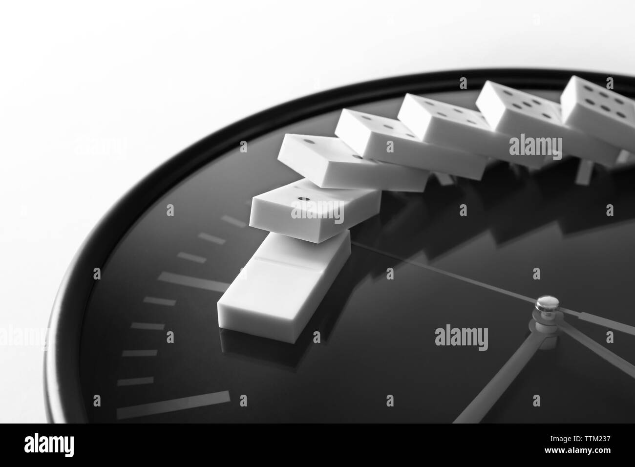 Dominoes and clock on light background Stock Photo - Alamy