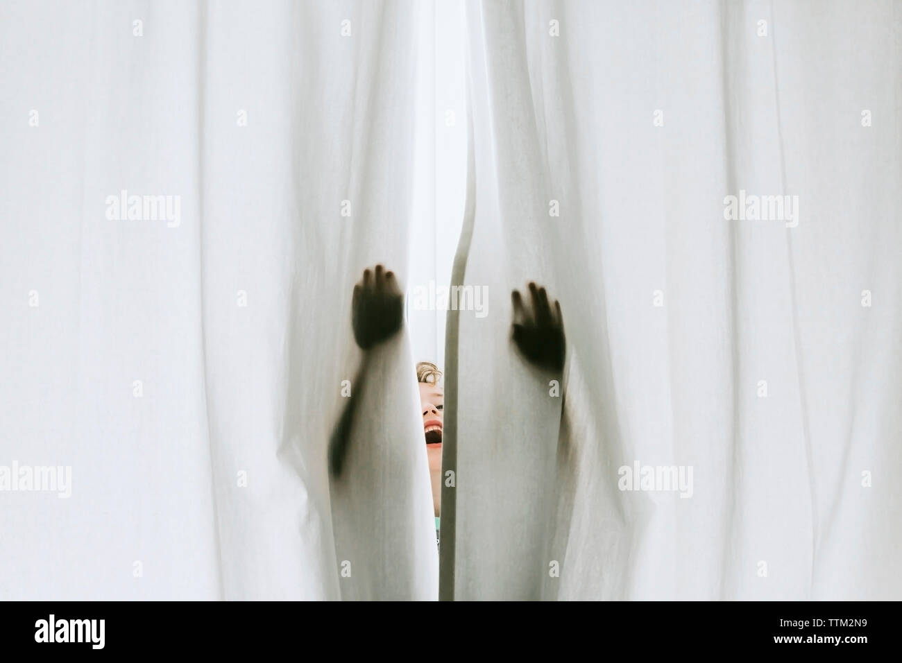 Person behind curtain hi-res stock photography and images - Alamy