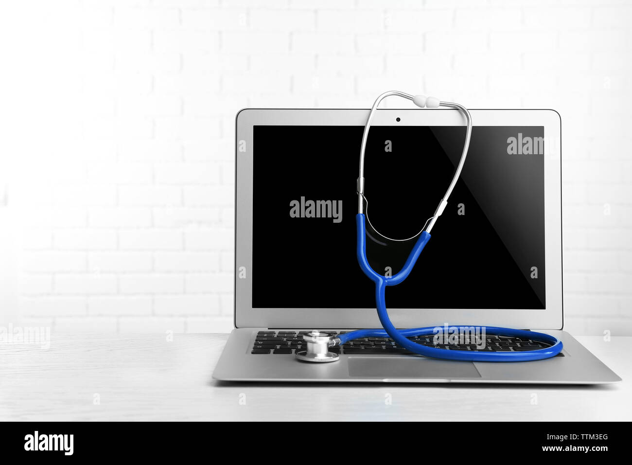 Laptop with stethoscope, isolated on white Stock Photo - Alamy