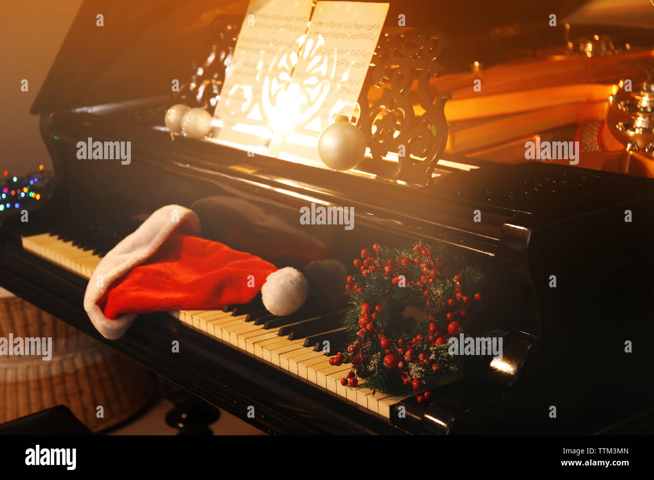 Santa hat on piano keys with Christmas decorations Stock Photo - Alamy