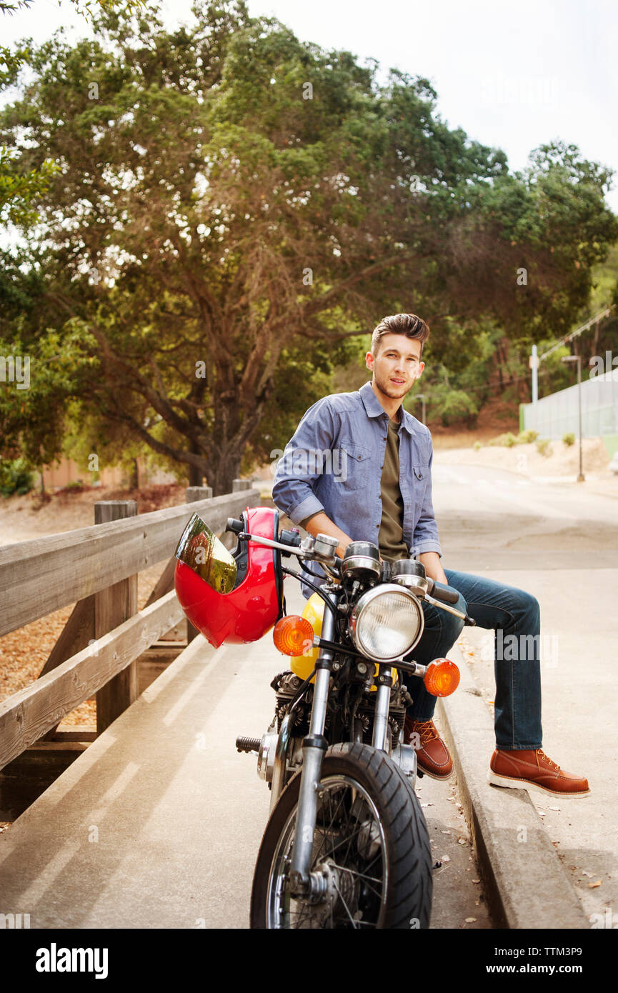 Portrait of handsome man sitting on motorcycle Stock Photo - Alamy