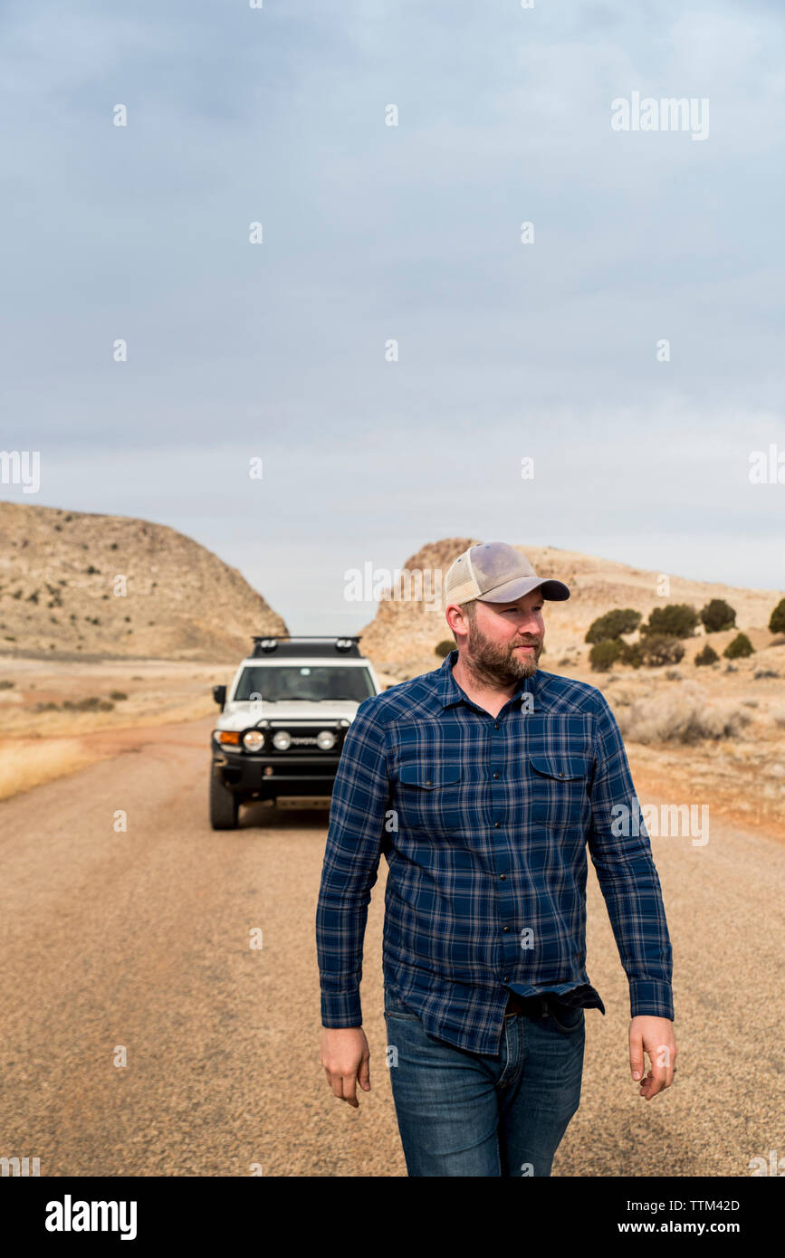 Man walking on desert road hi-res stock photography and images - Alamy