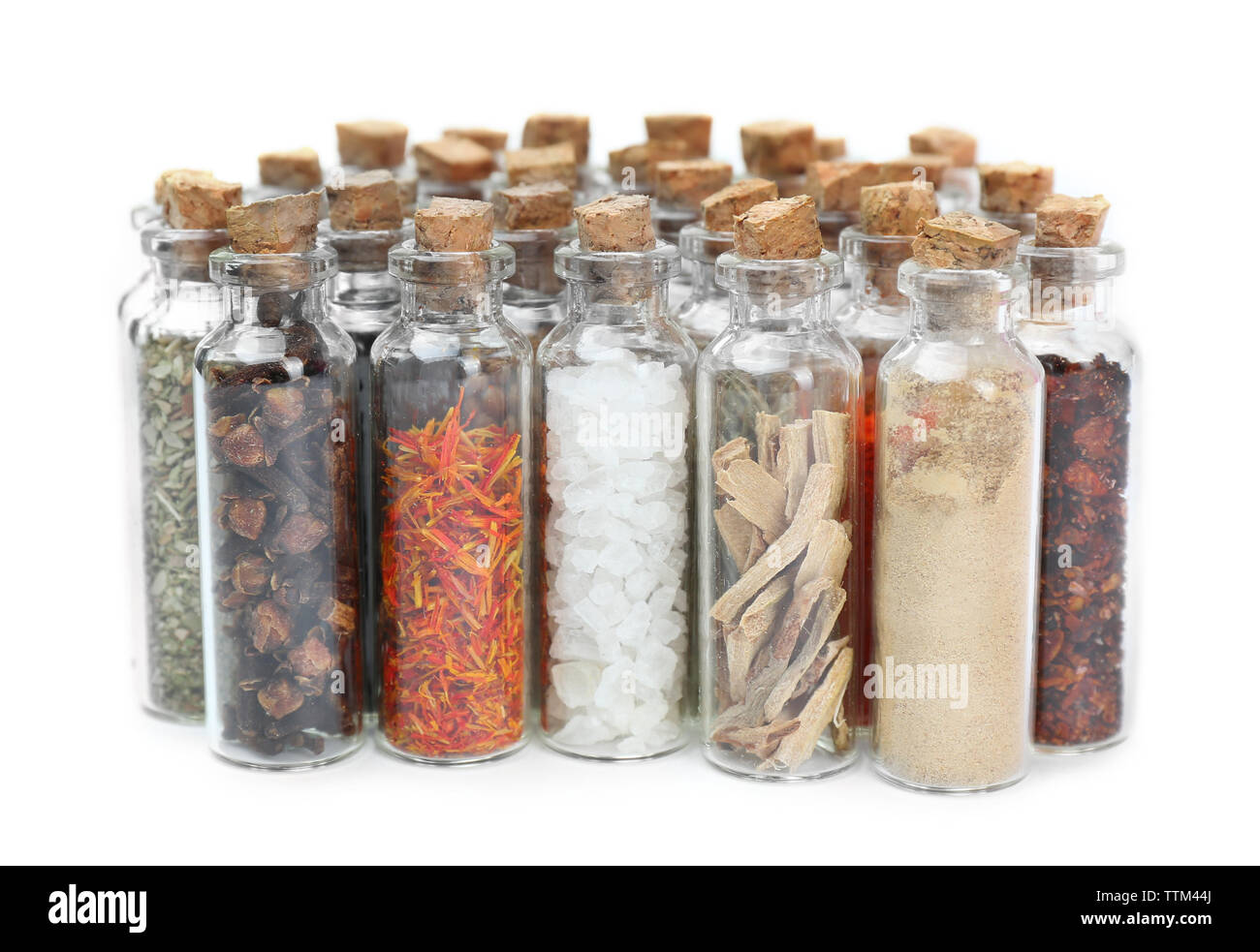 Assorted dry spices in glass bottles on white background Stock Photo ...
