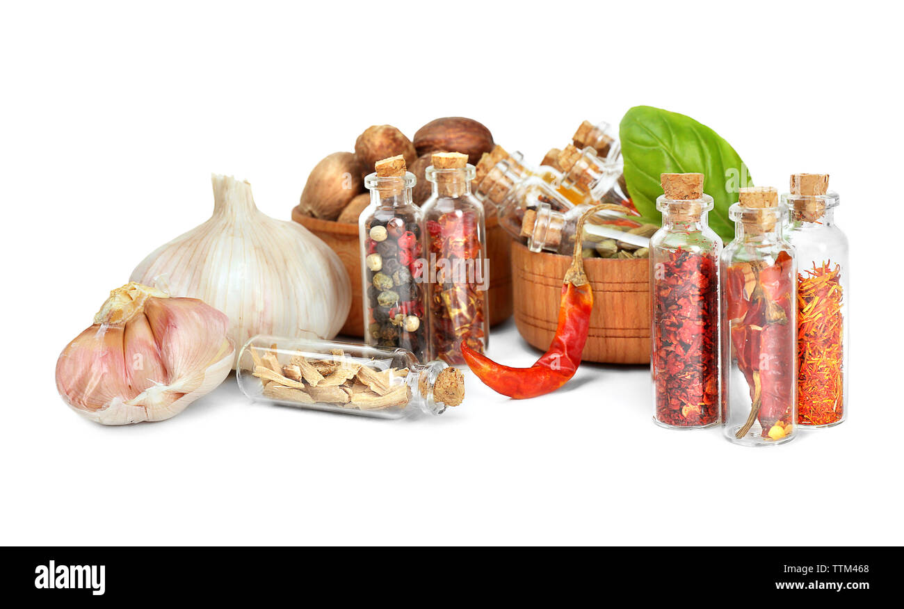 Assorted dry spices in glass bottles on white background Stock Photo ...