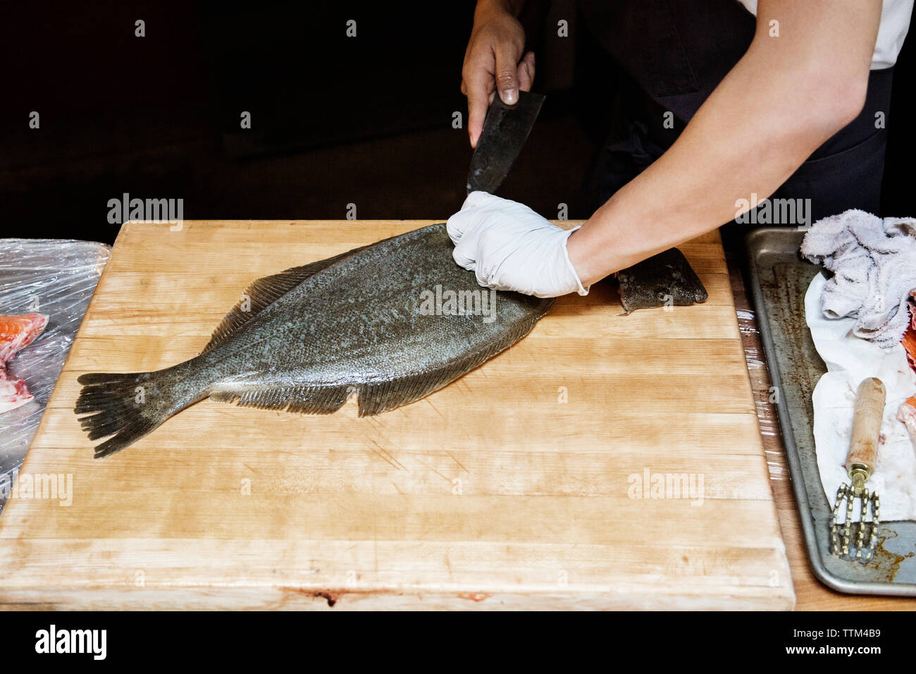 Cropped image of chef cutting fish on cutting board Stock Photo - Alamy