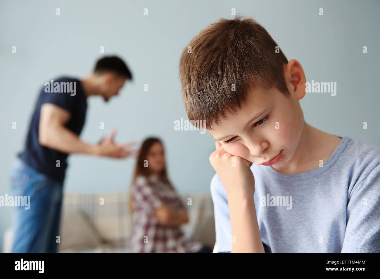 Family problems concept. Sad boy and abusing parents Stock Photo - Alamy