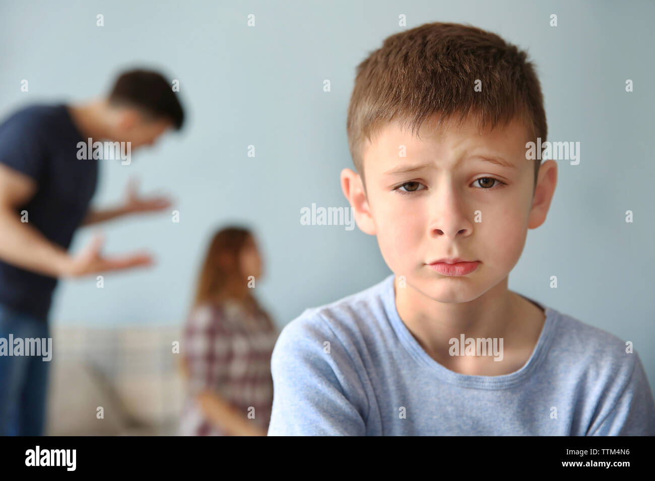 Family problems concept. Sad boy and abusing parents Stock Photo - Alamy