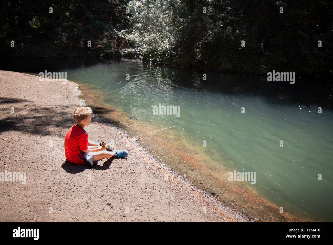 Boy fishing in river hi-res stock photography and images - Alamy