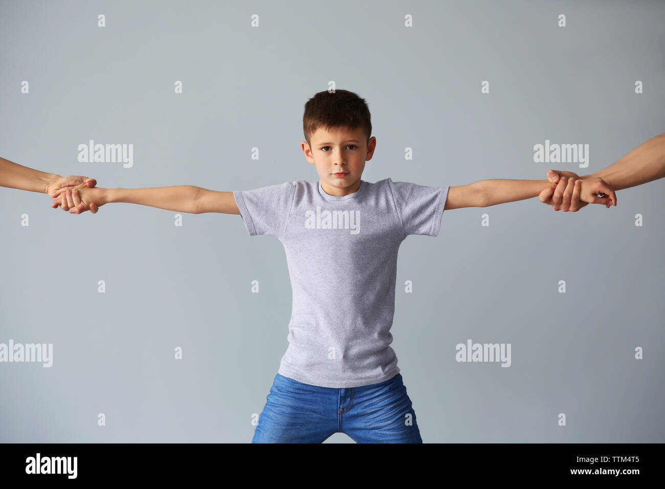 Family problems concept. Little boy between parents Stock Photo - Alamy