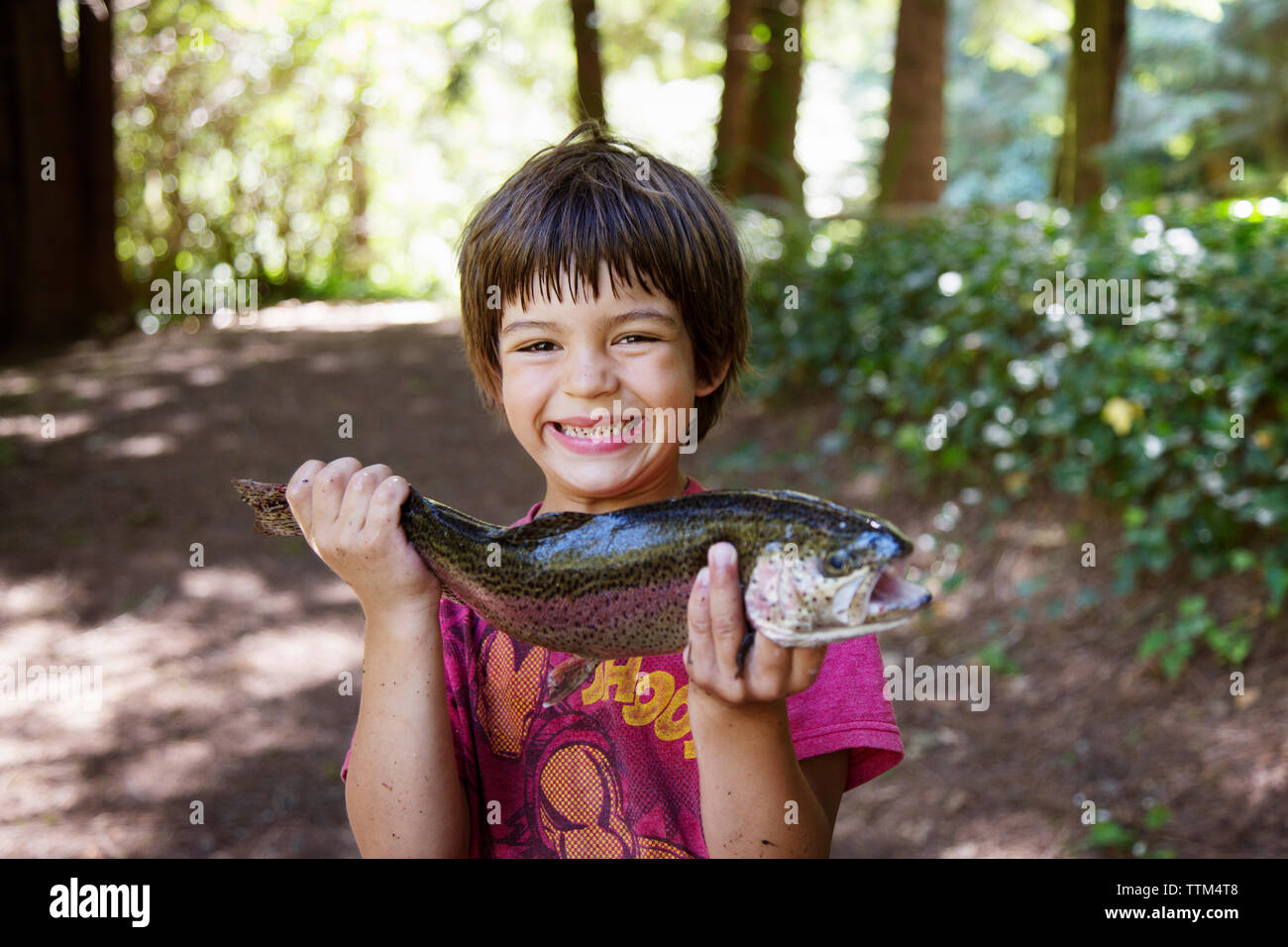 Boy holding fish Stock Photo - Alamy