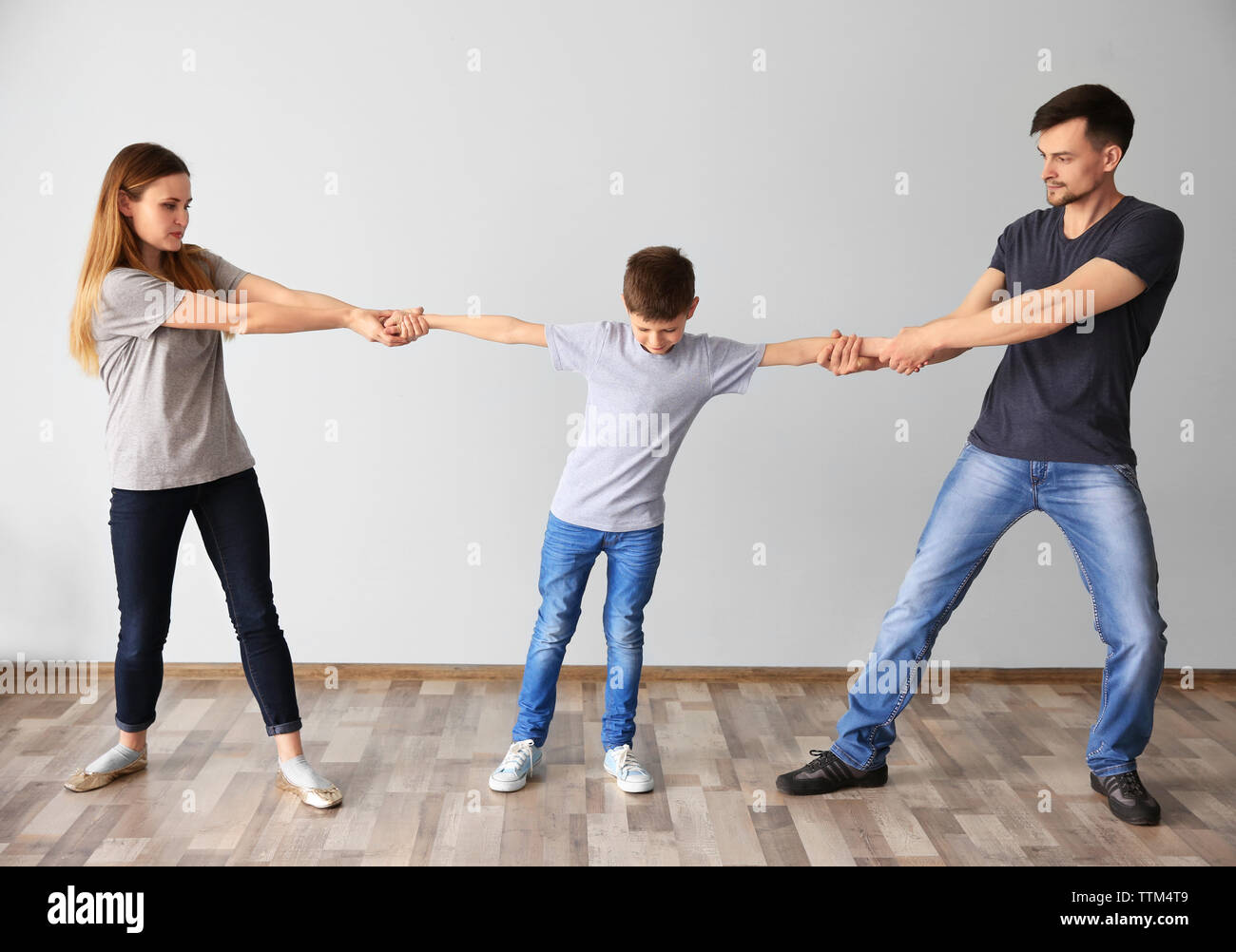 Family problems concept. Little boy between parents Stock Photo - Alamy