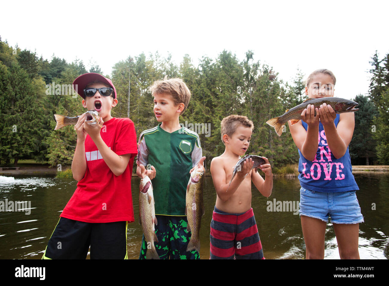 Children holding fish Stock Photo - Alamy