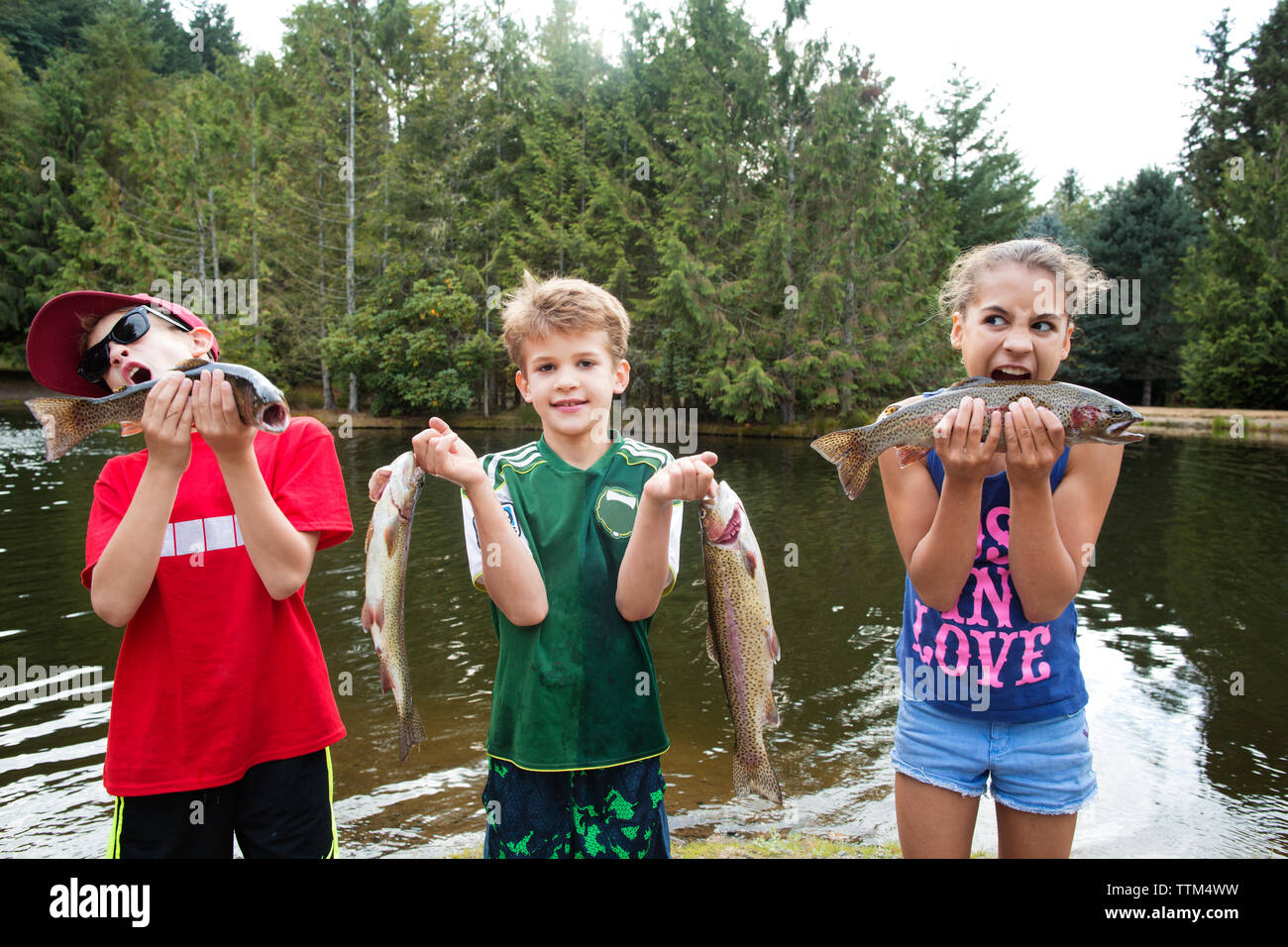 Children holding fish Stock Photo - Alamy