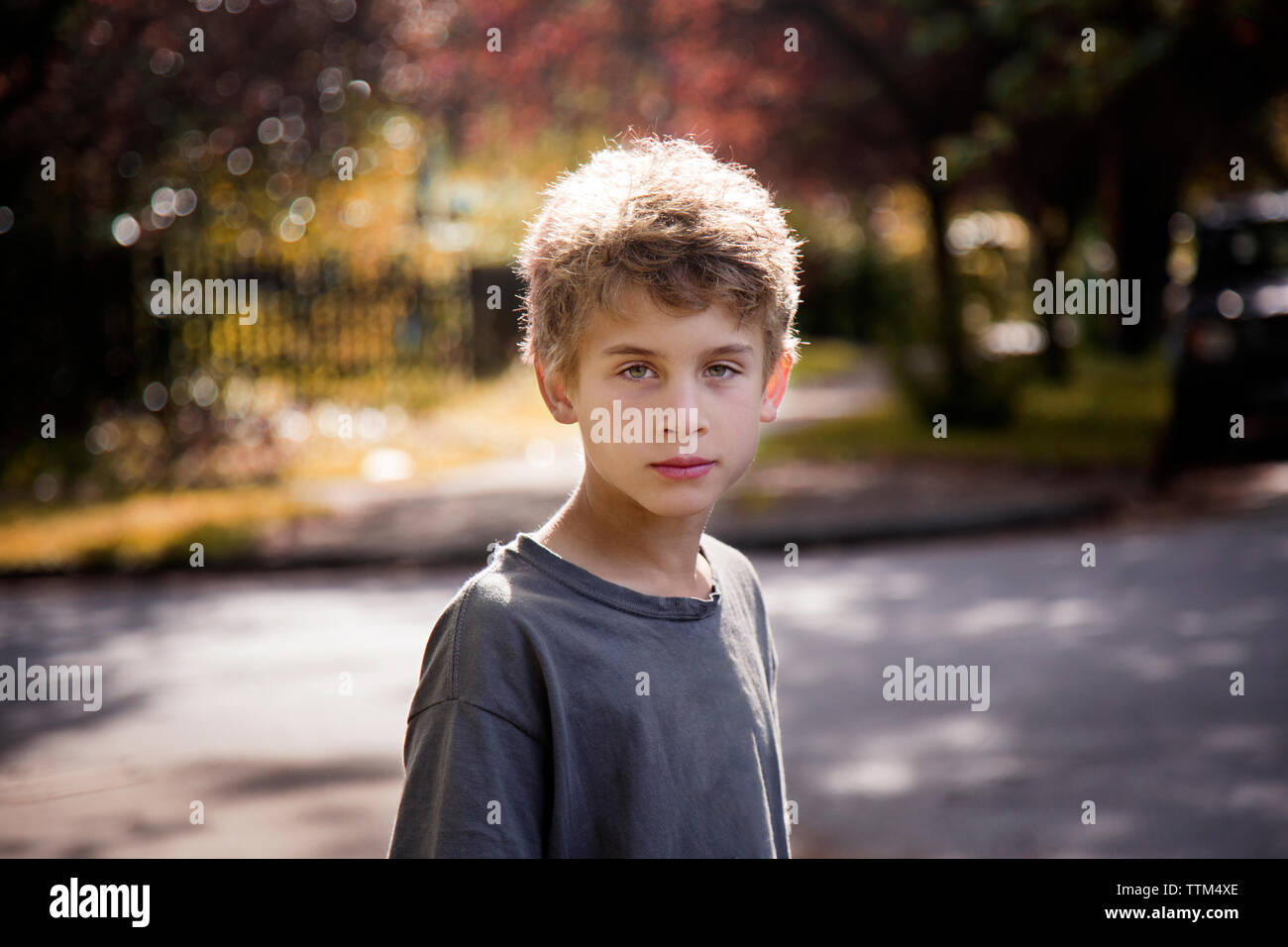 One boy standing in street hi-res stock photography and images - Alamy