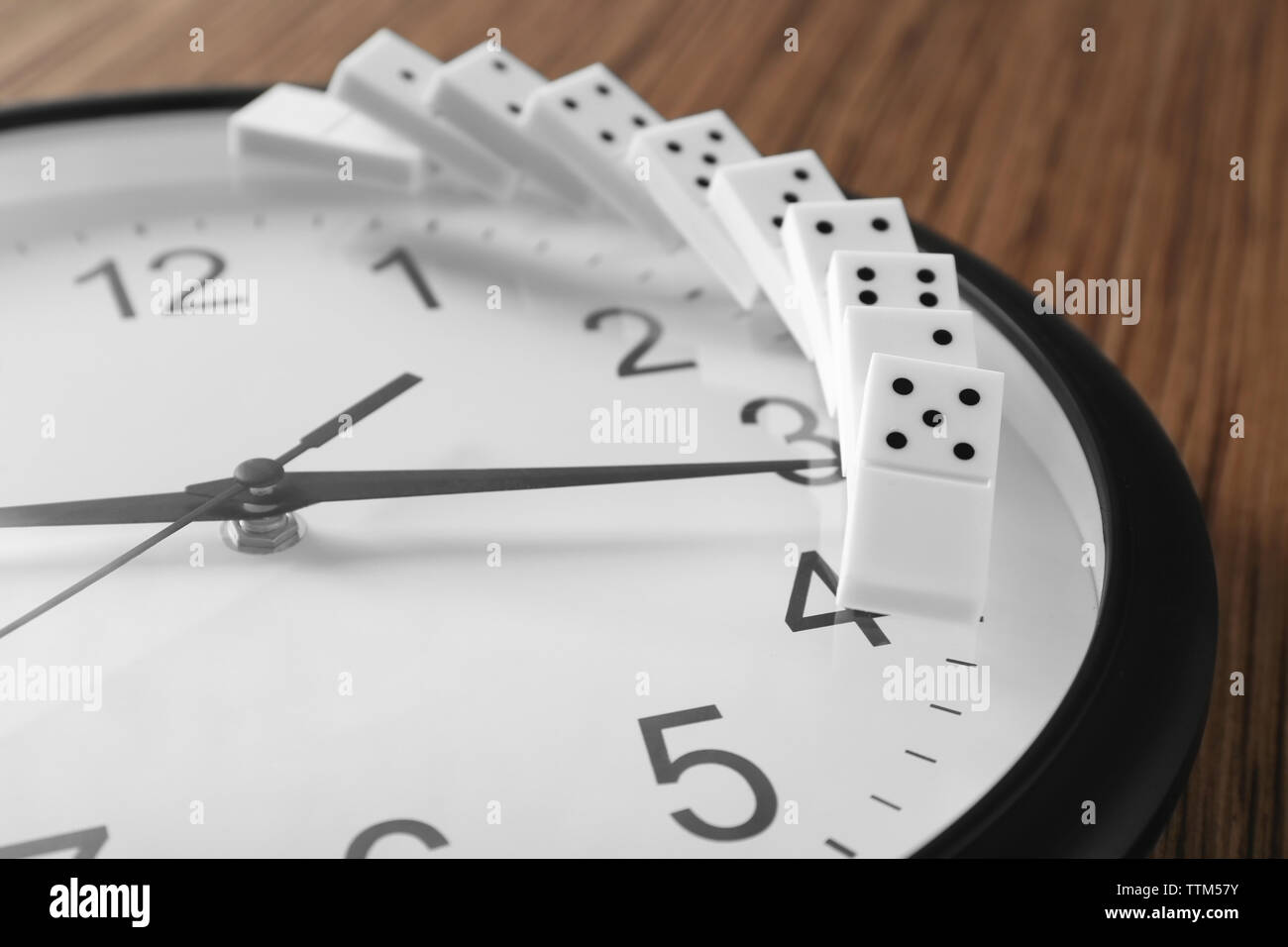 Dominoes on clock, closeup Stock Photo - Alamy