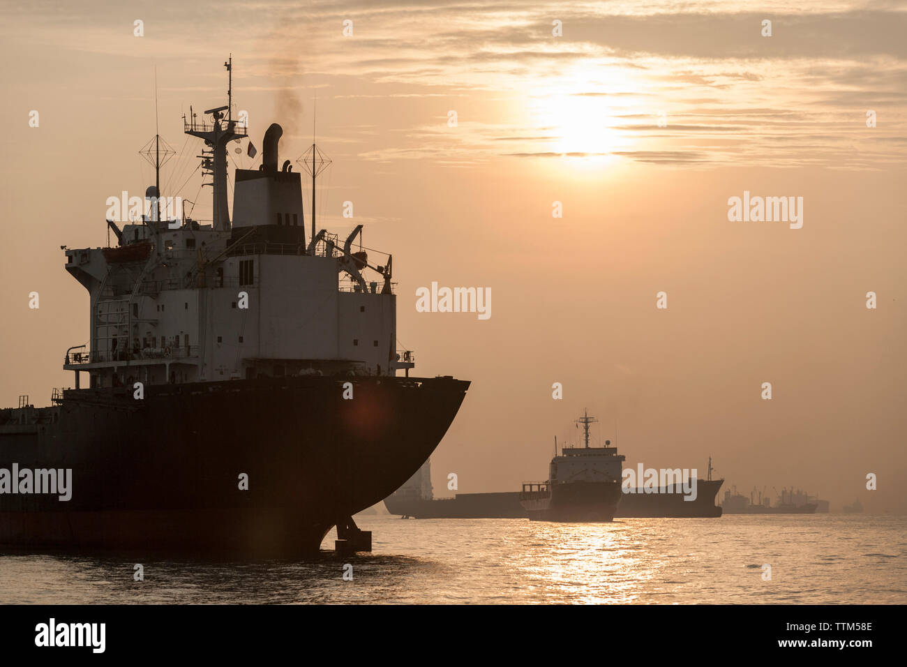 Cargo ship in sea during sunset Stock Photo - Alamy