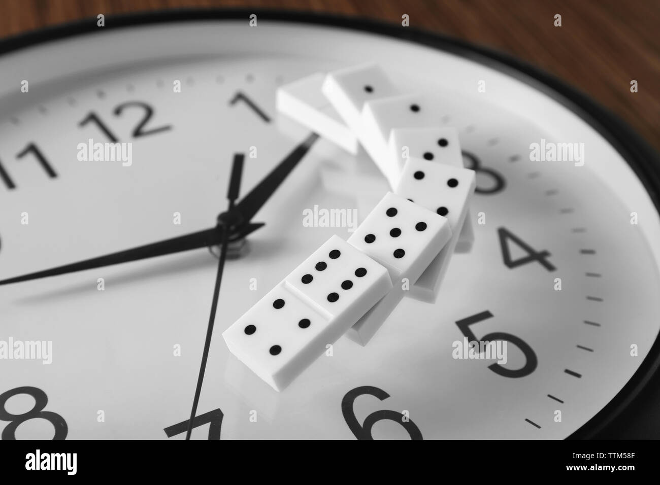 Dominoes on clock, closeup Stock Photo - Alamy