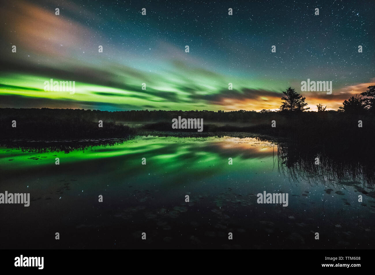 Reflection of aurora borealis on calm lake at night Stock Photo - Alamy