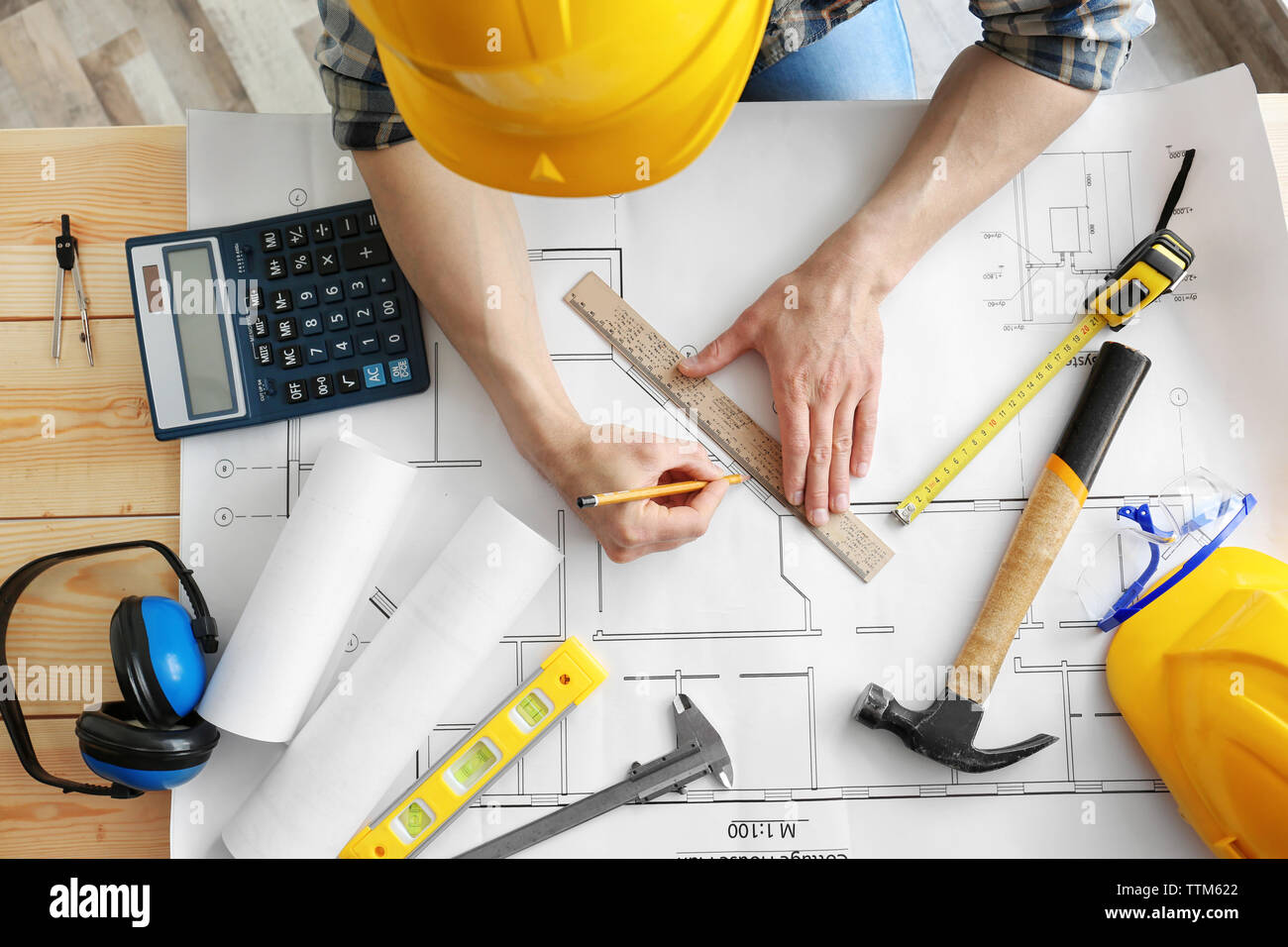 Man working with engineer blueprints Stock Photo - Alamy