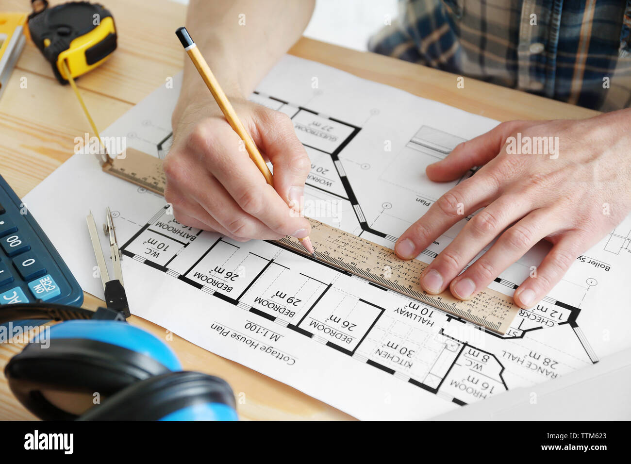 Man working with engineer blueprints Stock Photo - Alamy