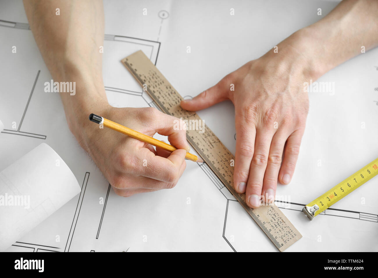 Man working with engineer blueprints Stock Photo - Alamy