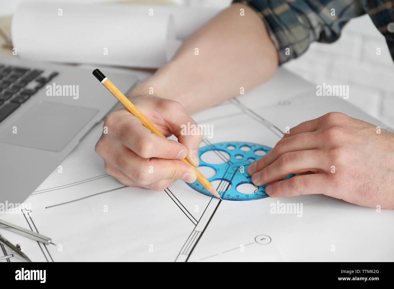 Man working with engineer blueprints Stock Photo - Alamy