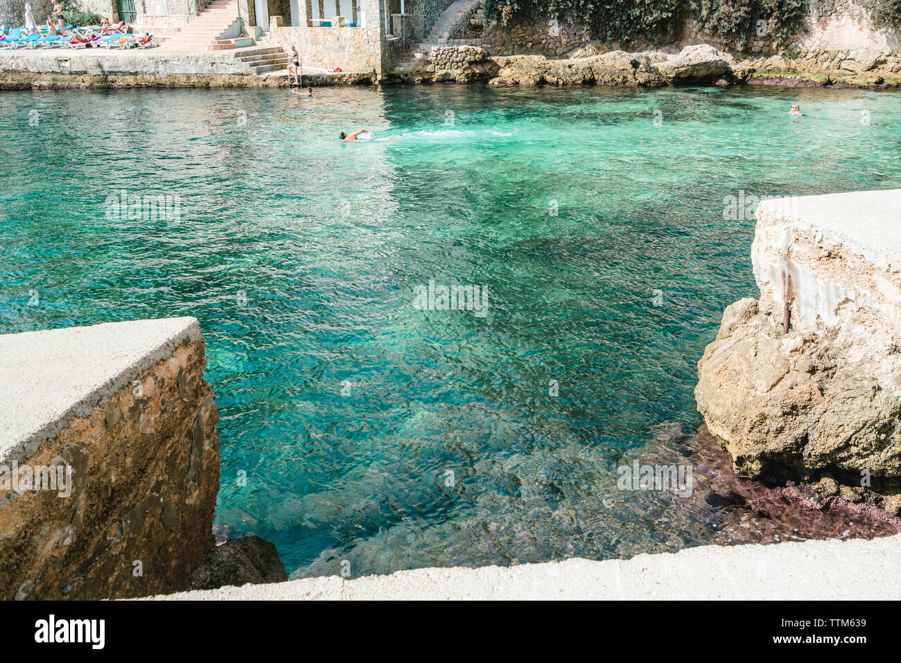 Tourists swimming in sea Stock Photo - Alamy