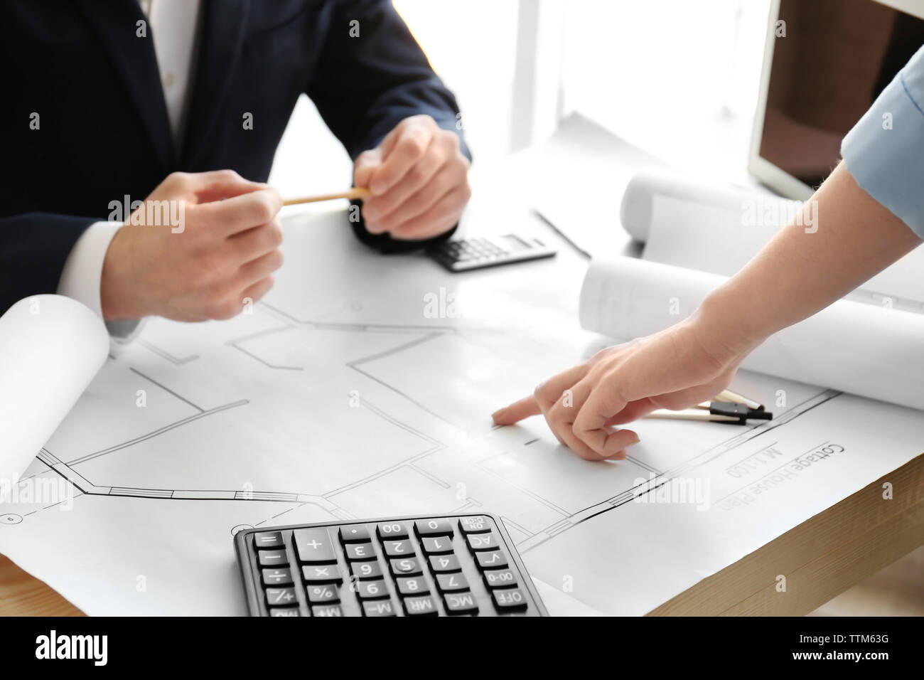 Engineers working with blueprints Stock Photo - Alamy