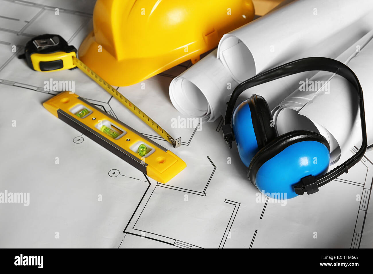 Construction plans and builder equipment on table Stock Photo - Alamy