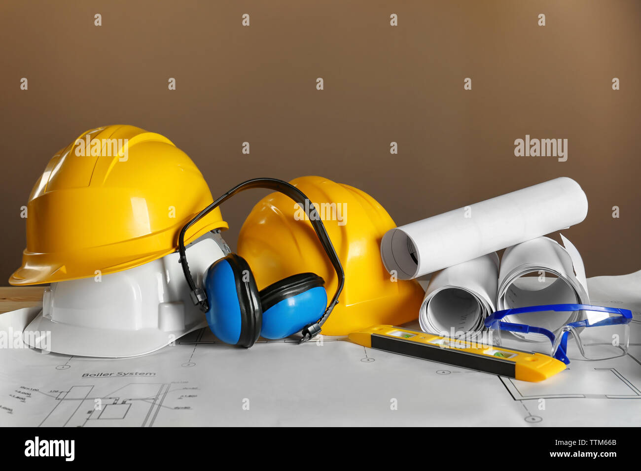 Construction plans and builder equipment on table Stock Photo - Alamy