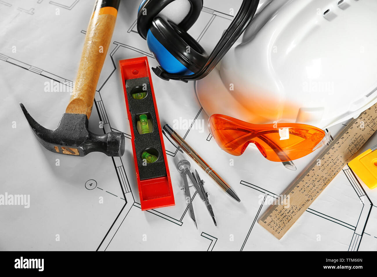 Construction plans and builder equipment on table Stock Photo - Alamy
