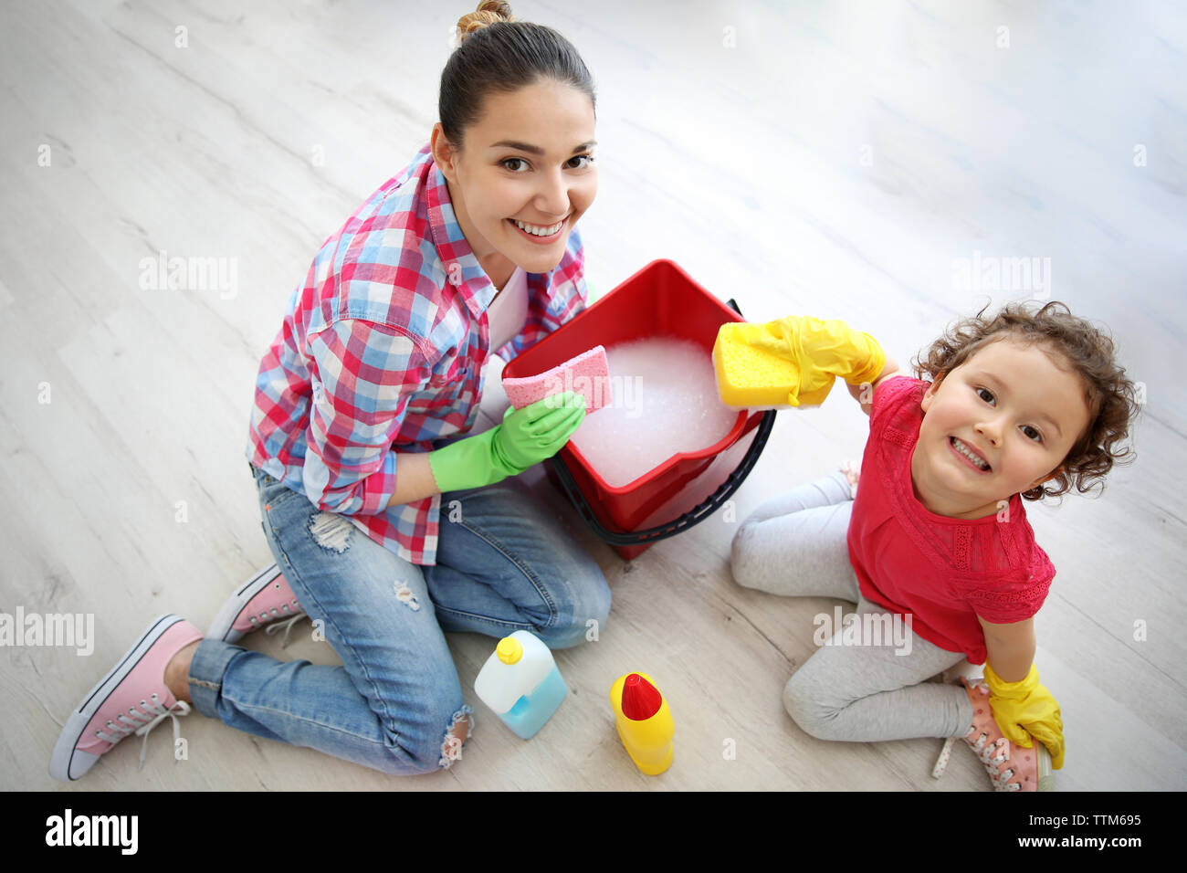 Happy family having fun and cleaning home Stock Photo - Alamy
