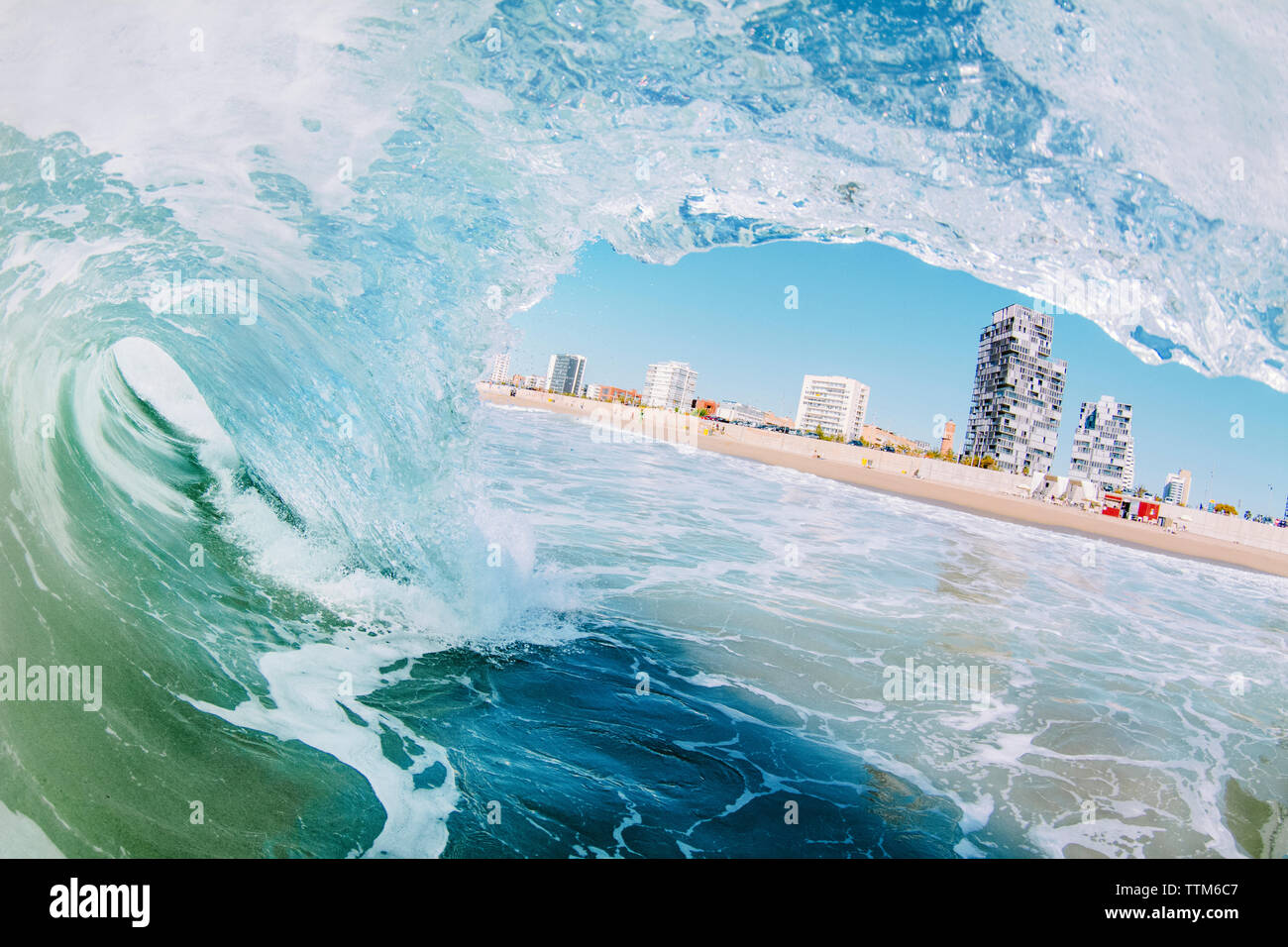Buildings seen through wave in sea Stock Photo - Alamy