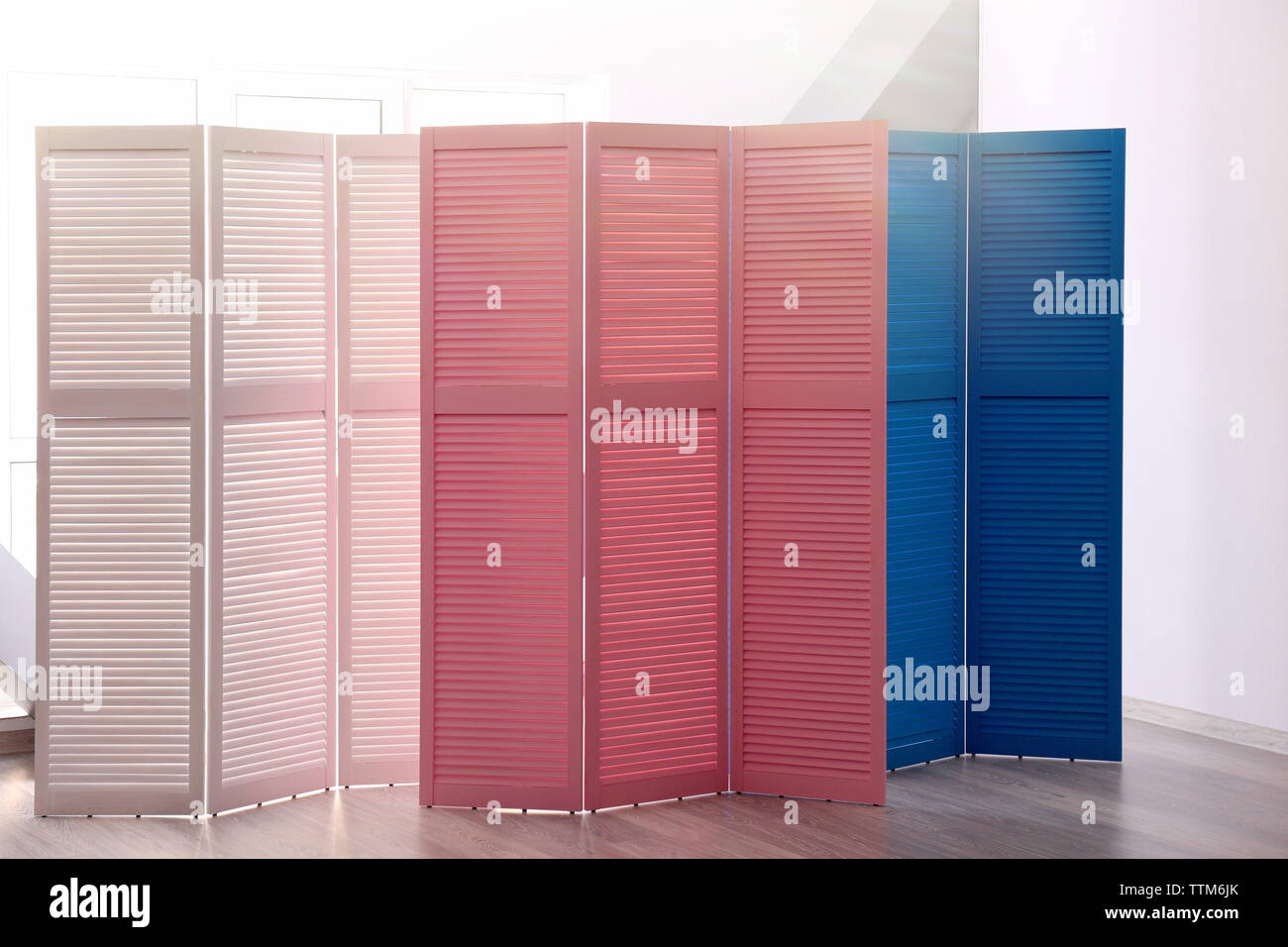 Color folding screens in room Stock Photo - Alamy