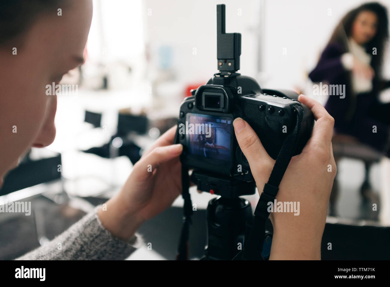 Woman photographing in studio Stock Photo - Alamy