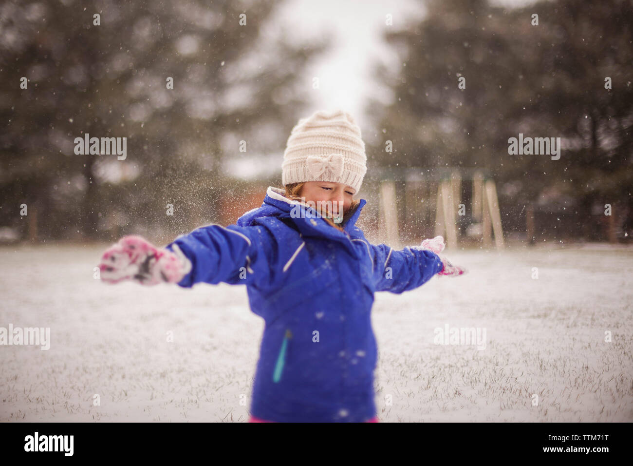 Happy girl enjoying snow Stock Photo - Alamy