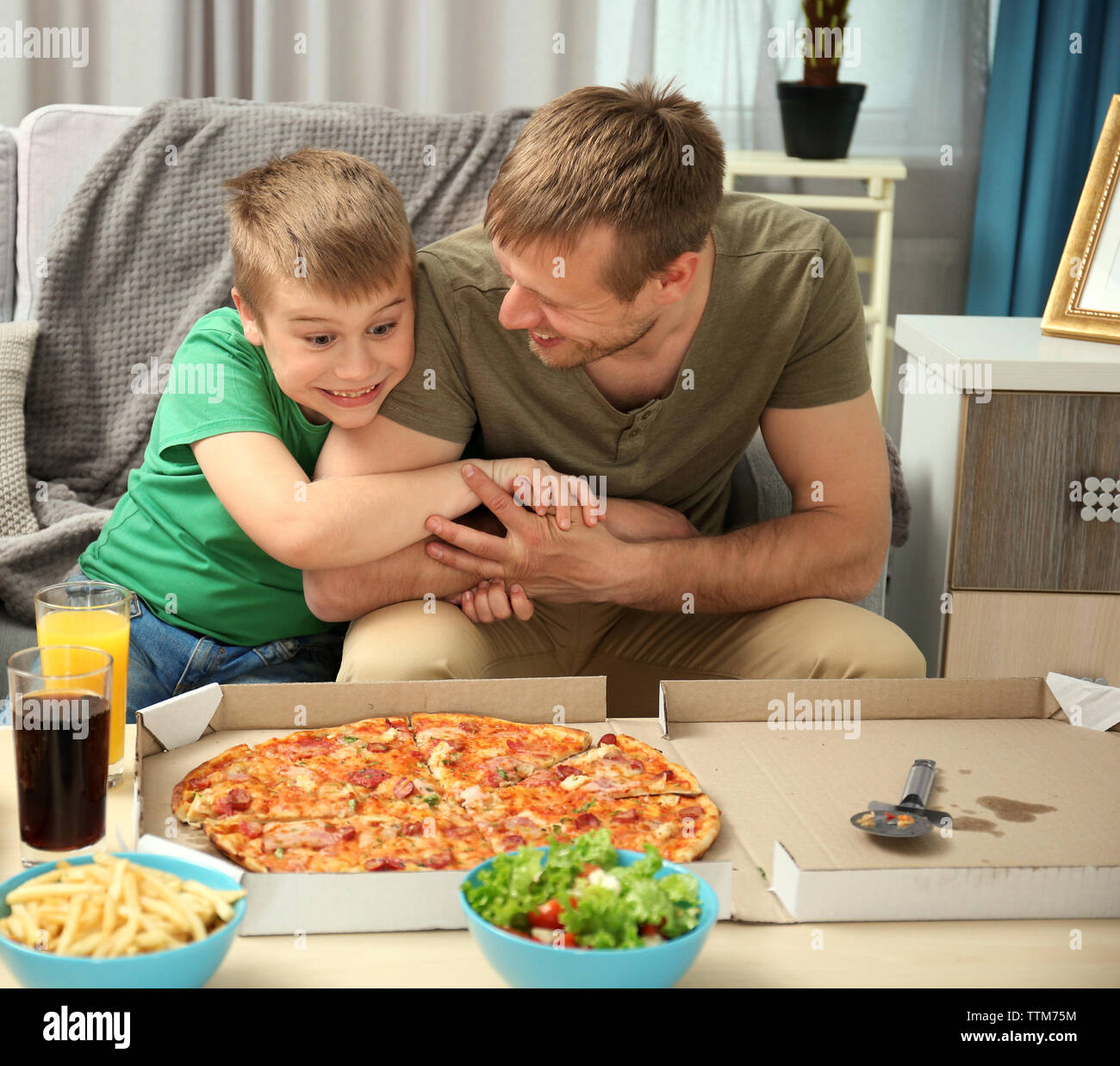 Happy lovely family eating pizza Stock Photo - Alamy