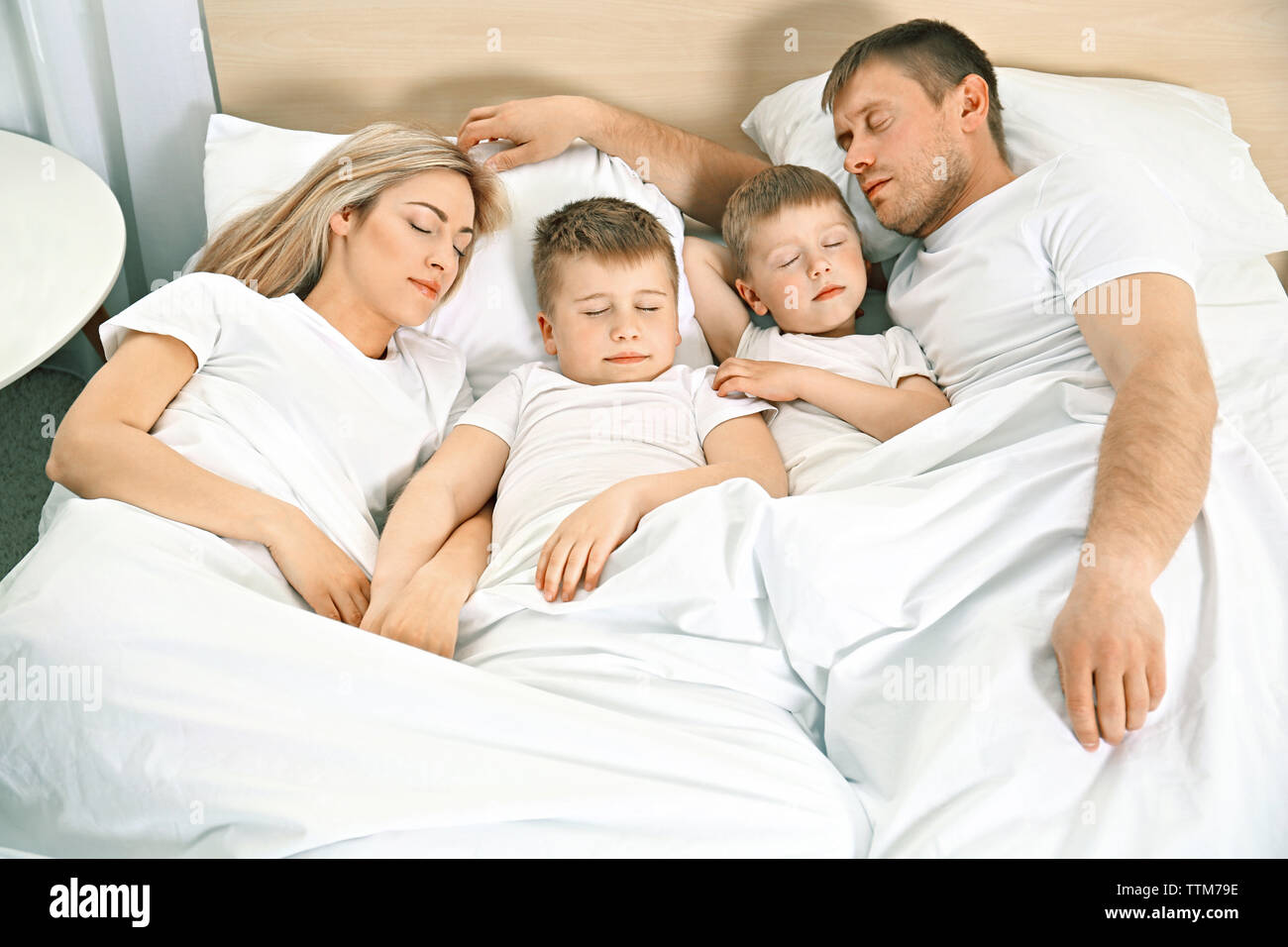 Lovely sleeping family in bed Stock Photo - Alamy