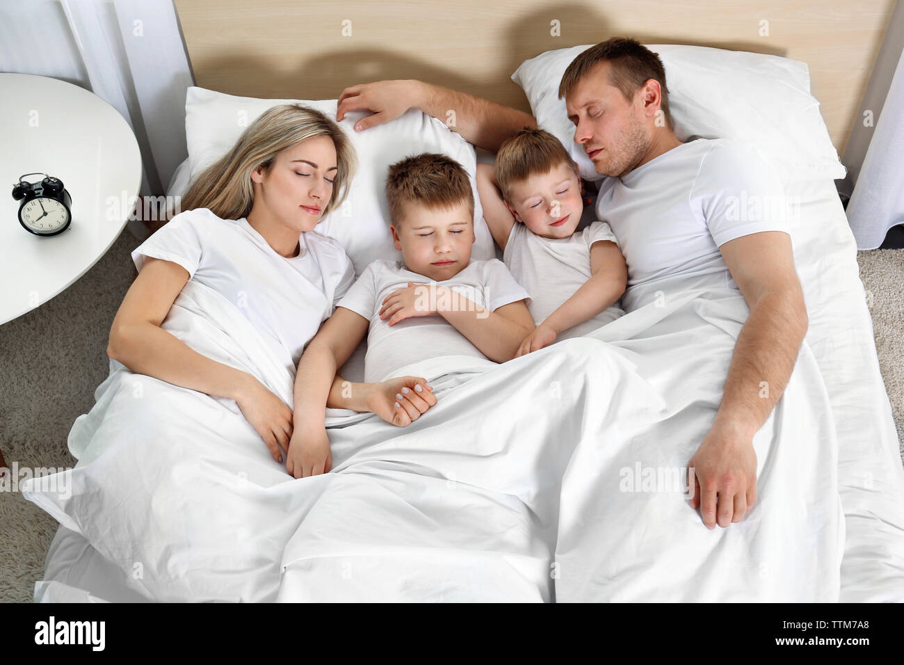 Lovely sleeping family in bed Stock Photo - Alamy