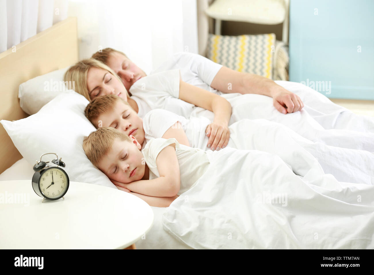 Lovely sleeping family in bed Stock Photo - Alamy