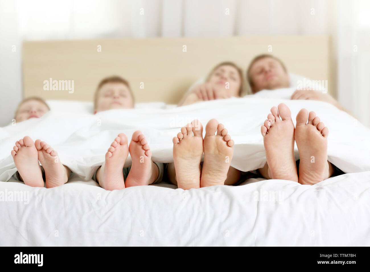 Lovely sleeping family in bed Stock Photo - Alamy
